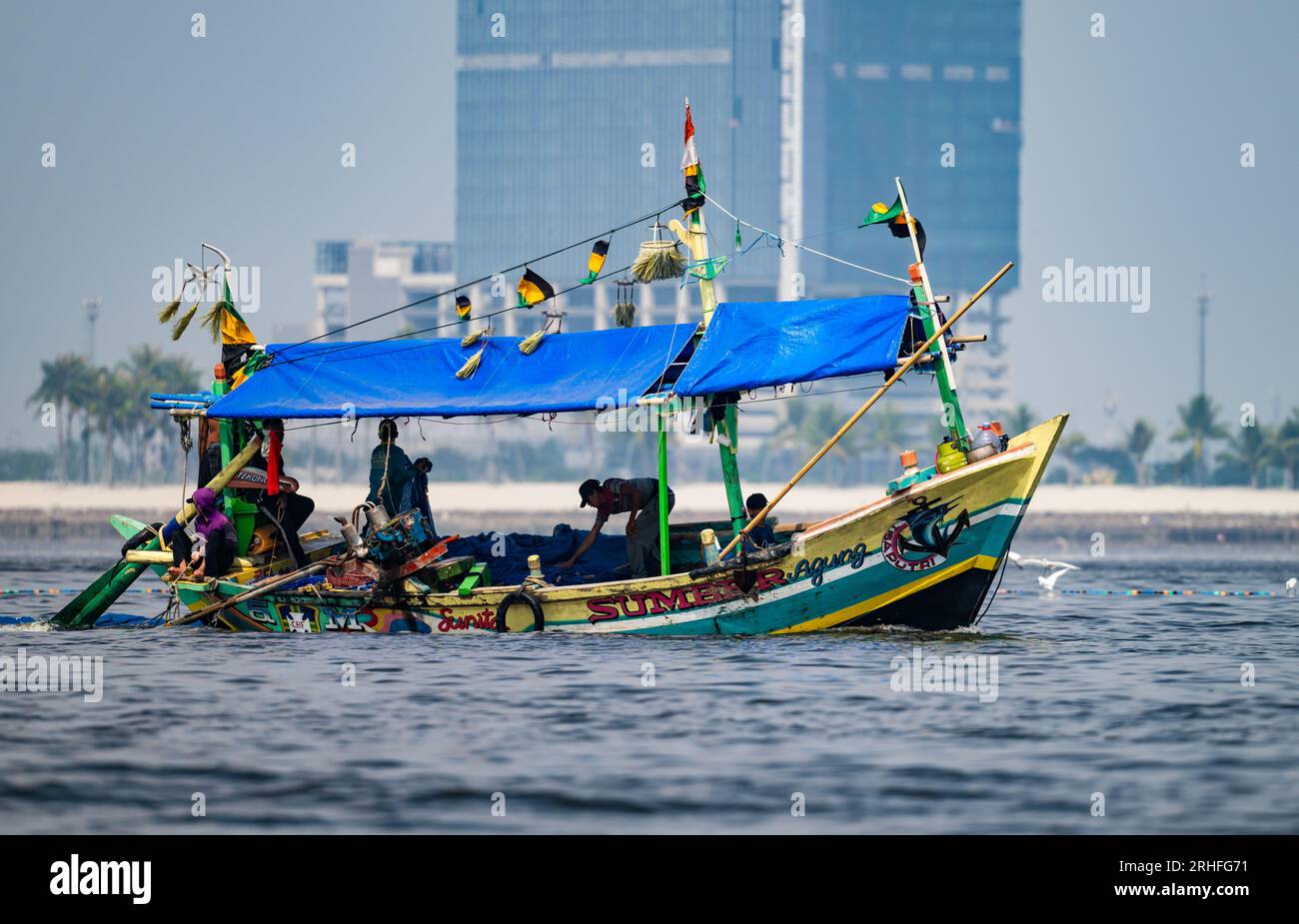 A wooden fishing boat sailing in the bay near Jakarta, Java, Indonesia ...