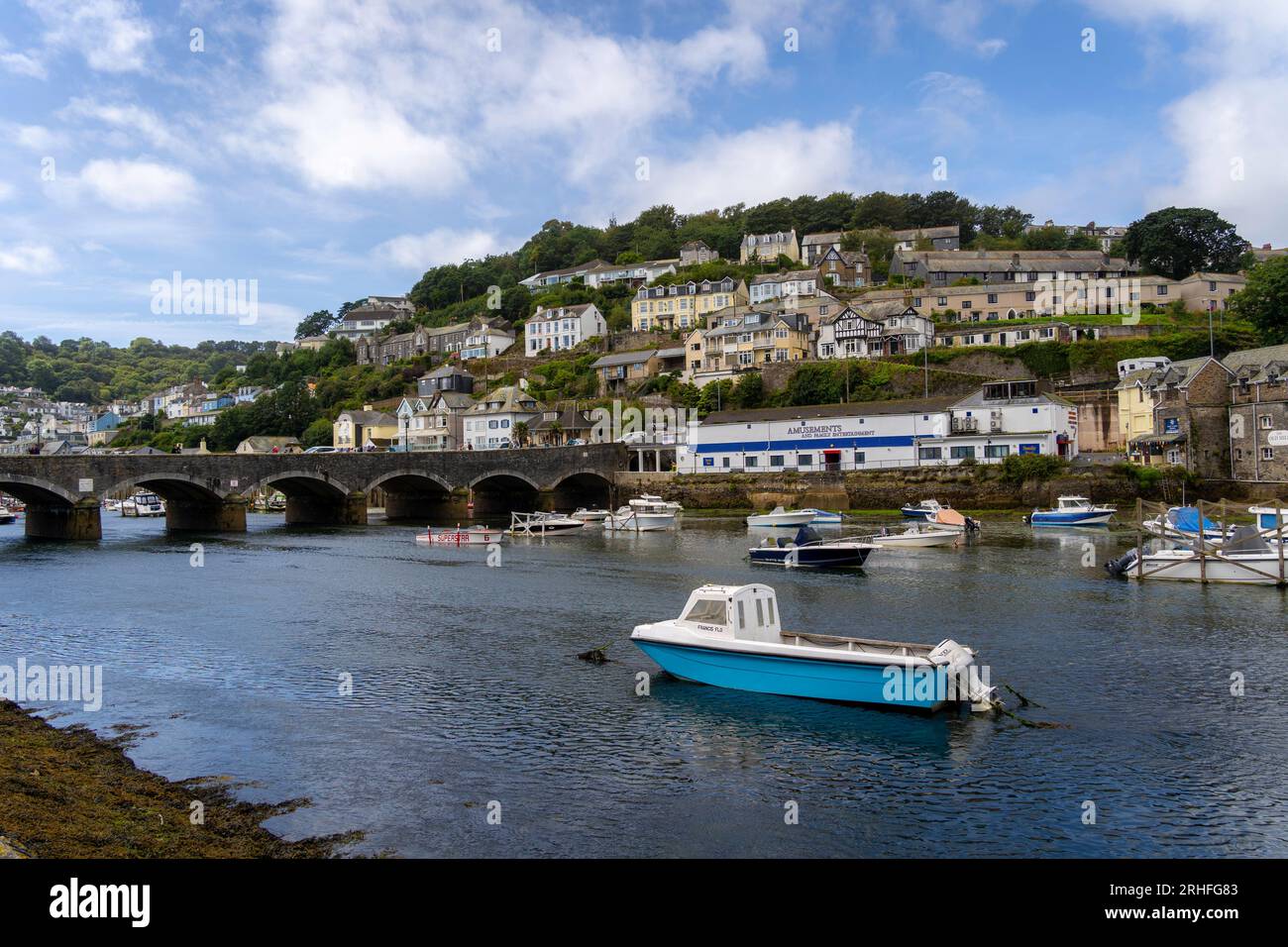 Looe, UK - August 2023: View of harbour and arched bridge over East ...