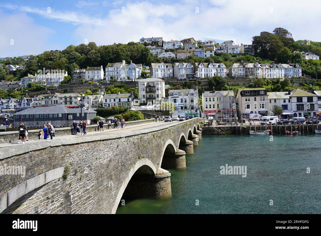 Looe, UK - August 2023: View of harbour and arched bridge over East ...