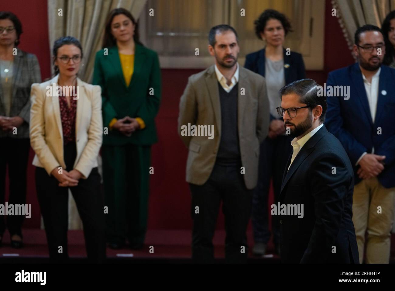 Chile's President Gabriel Boric walks in front his ministers during a ...