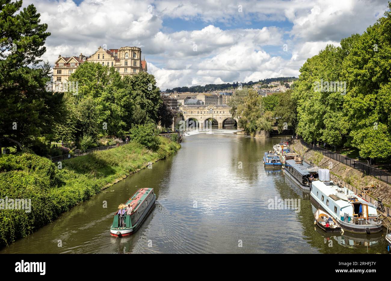 Canal Boat on the River Avon travelling towards Pulteney Bridge in Bath ...