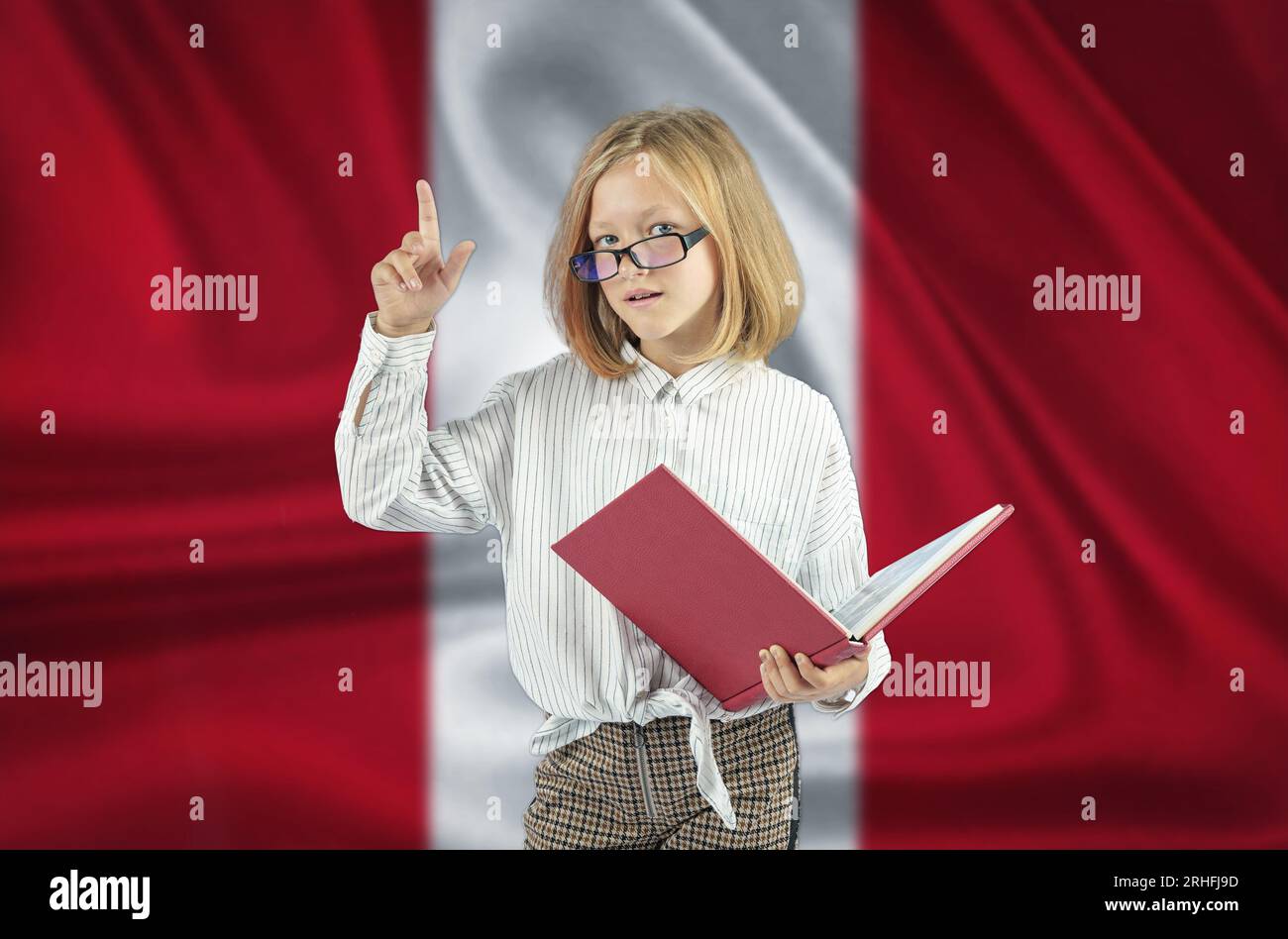 A girl with a book in her hand shows a gesture - attention on the ...