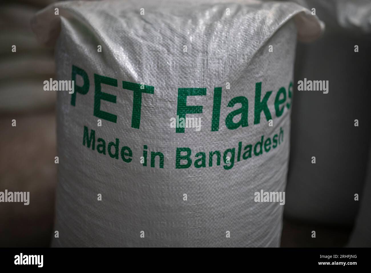 A sack of plastic flakes made by used plastic bottles at a recycling ...