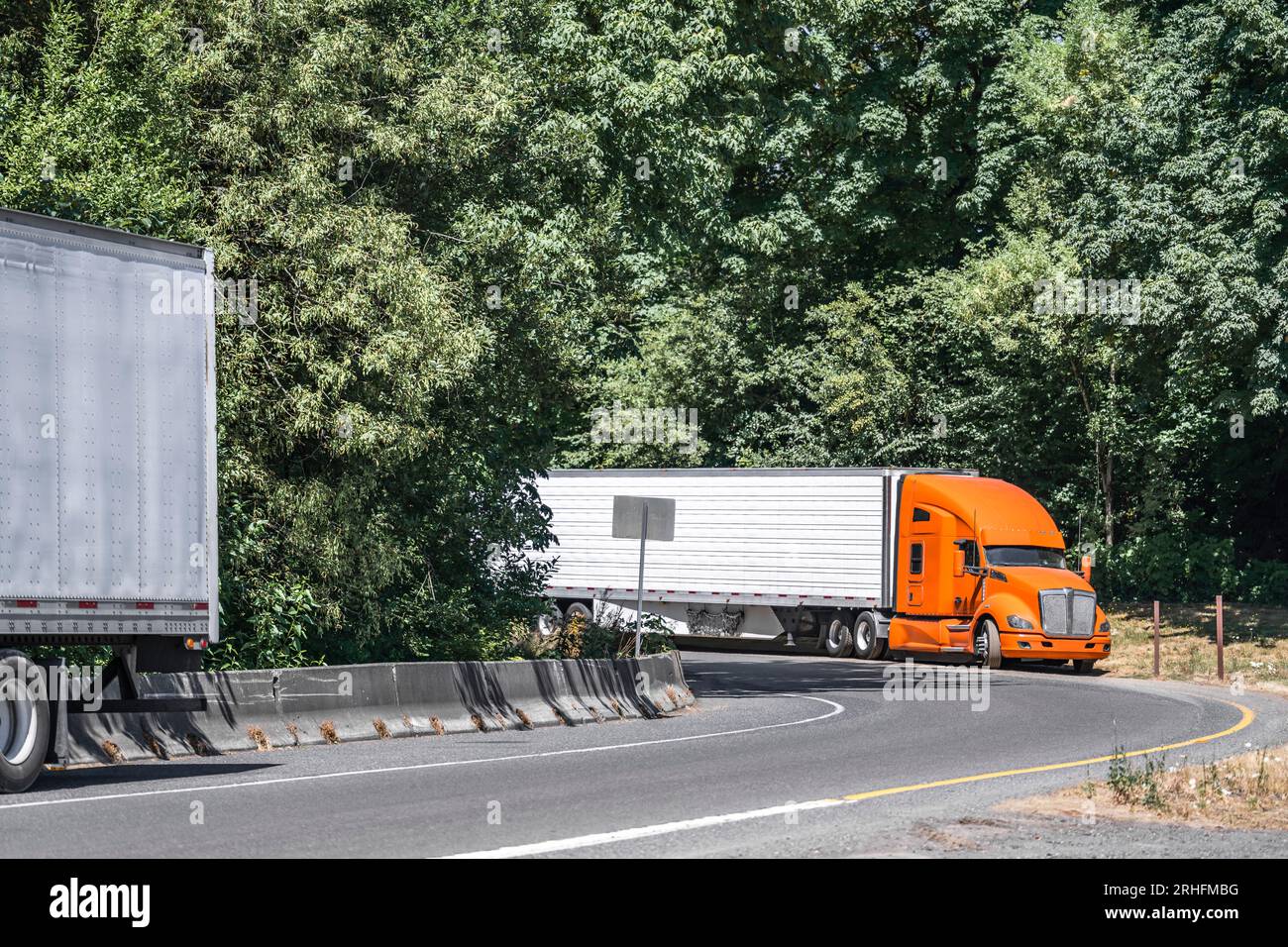 Long haul big rig orange semi truck with refrigerator semi trailer ...