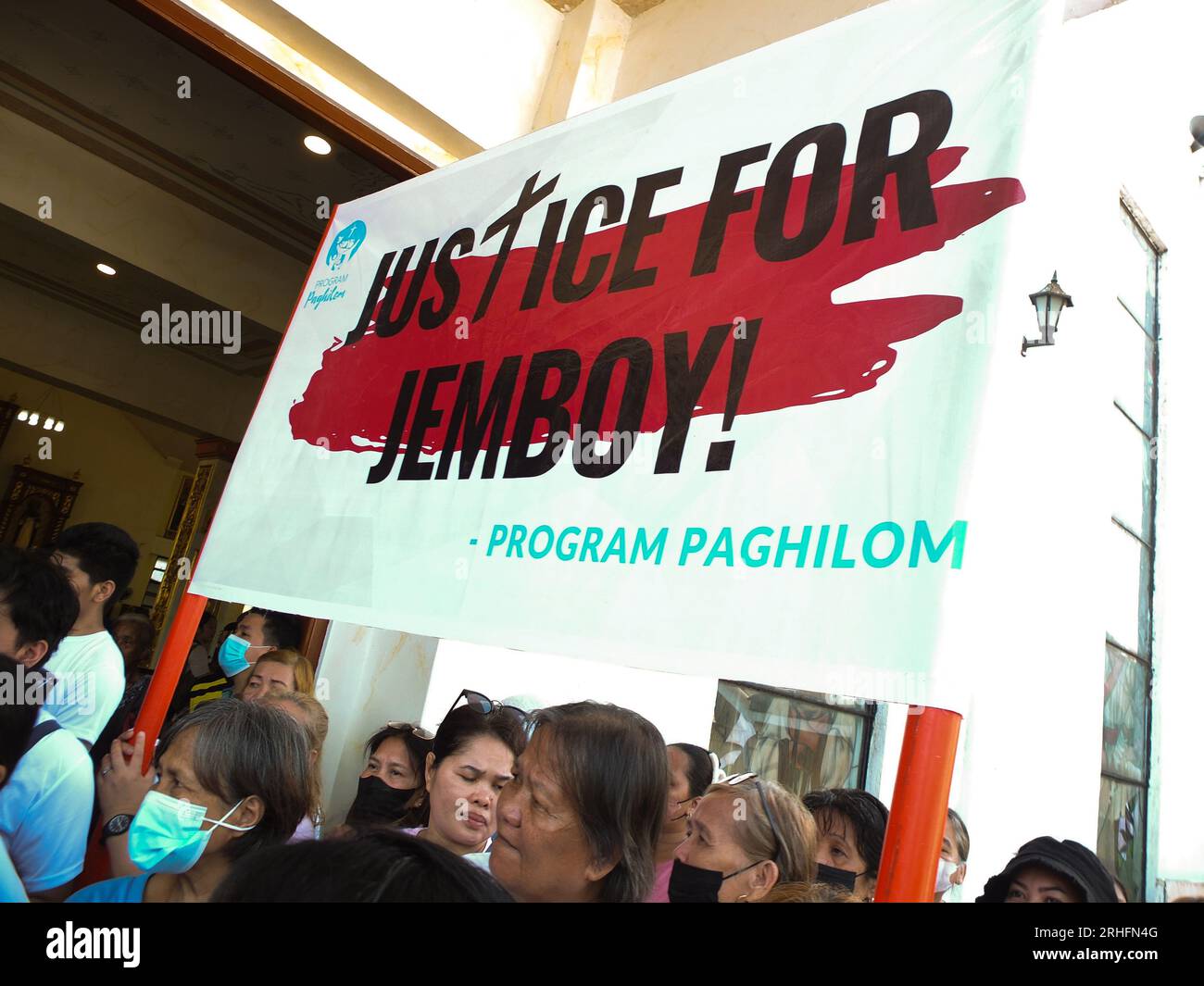 Caloocan, Philippines. 16th Aug, 2023. Mourners hold a banner with ...