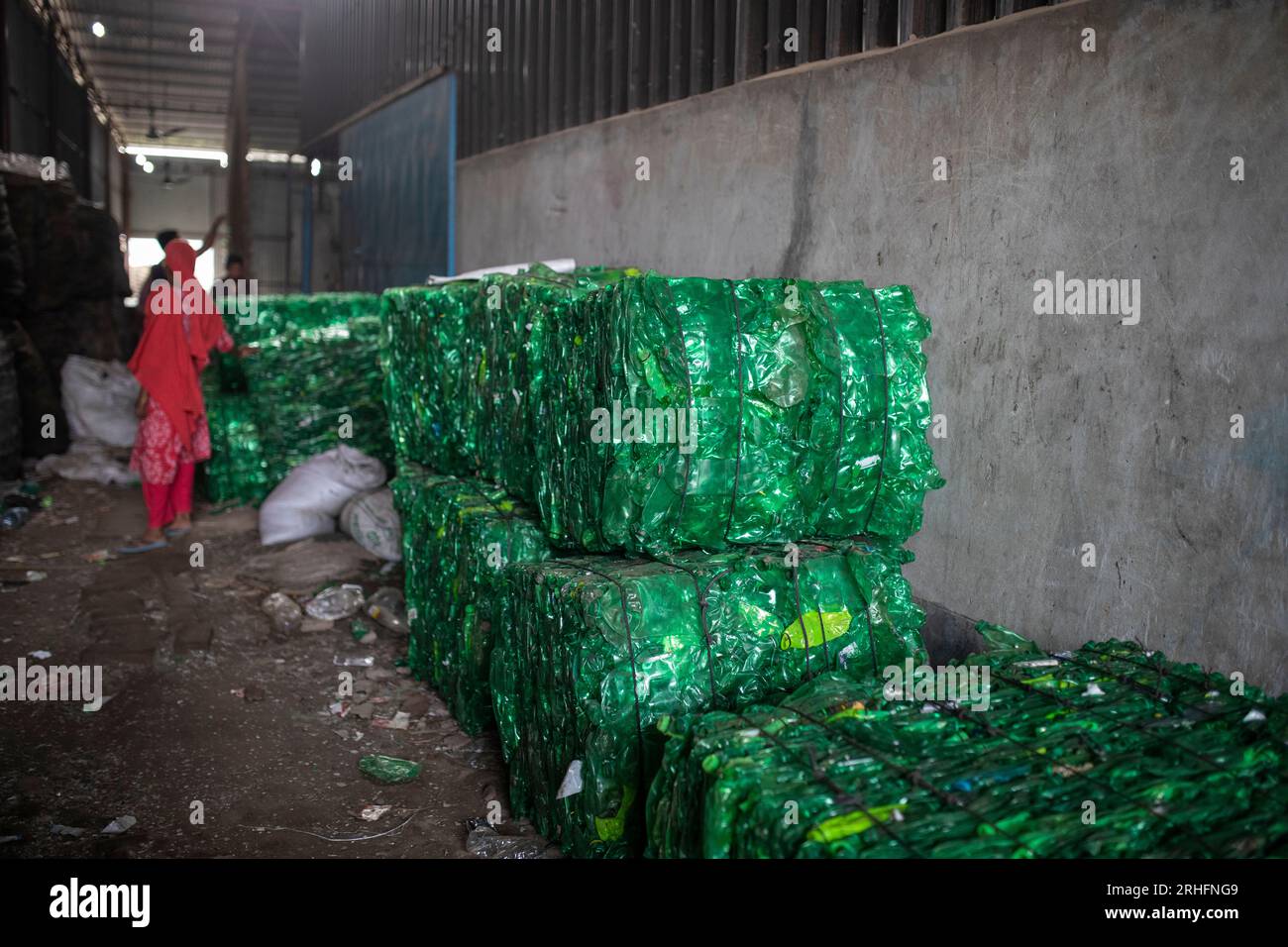 Compacted recyclable plastic bottles at a recycling plant in Dhaka ...
