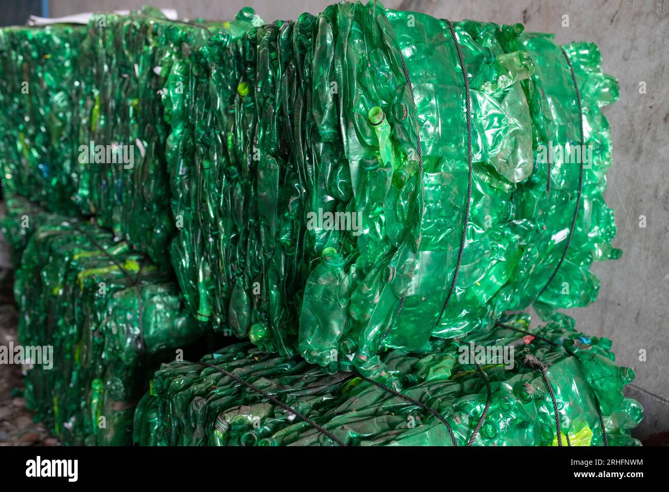 Compacted recyclable plastic bottles at a recycling plant in Dhaka ...