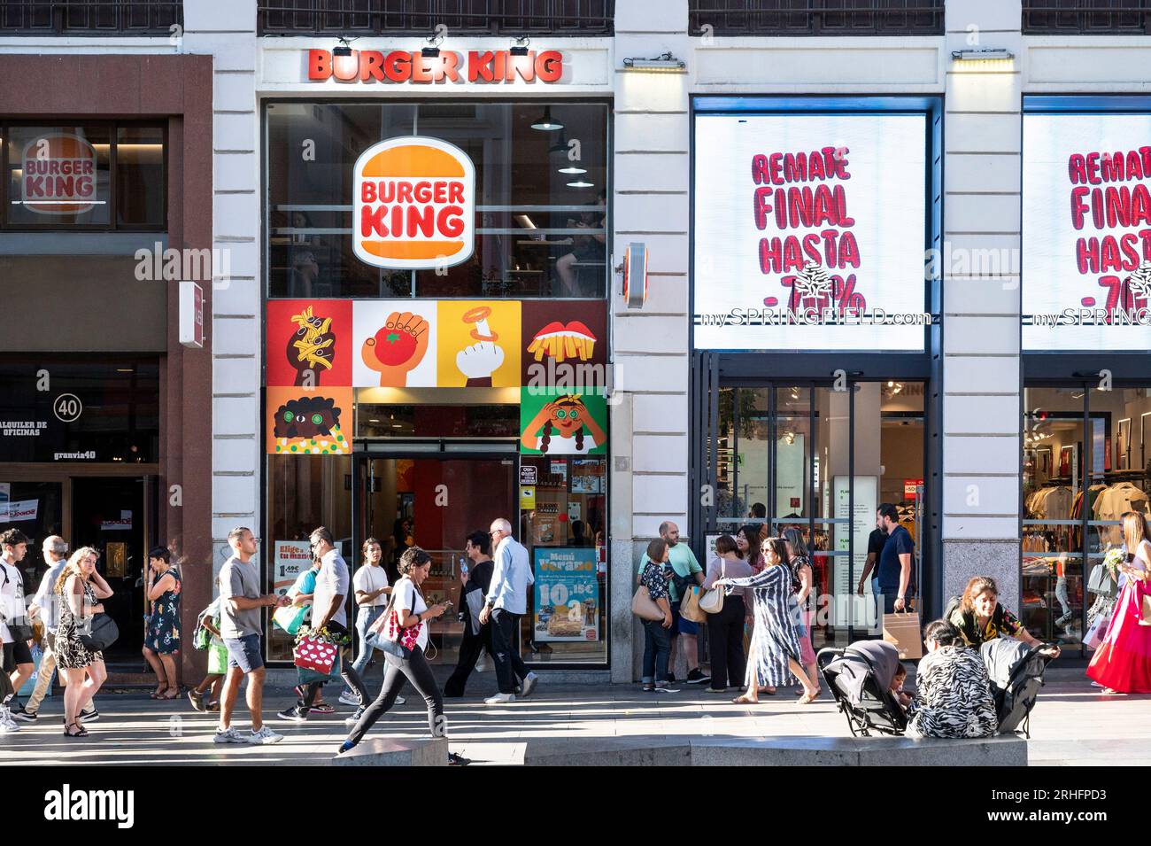 Pedestrians walk past the American fast-food hamburger Burger King ...