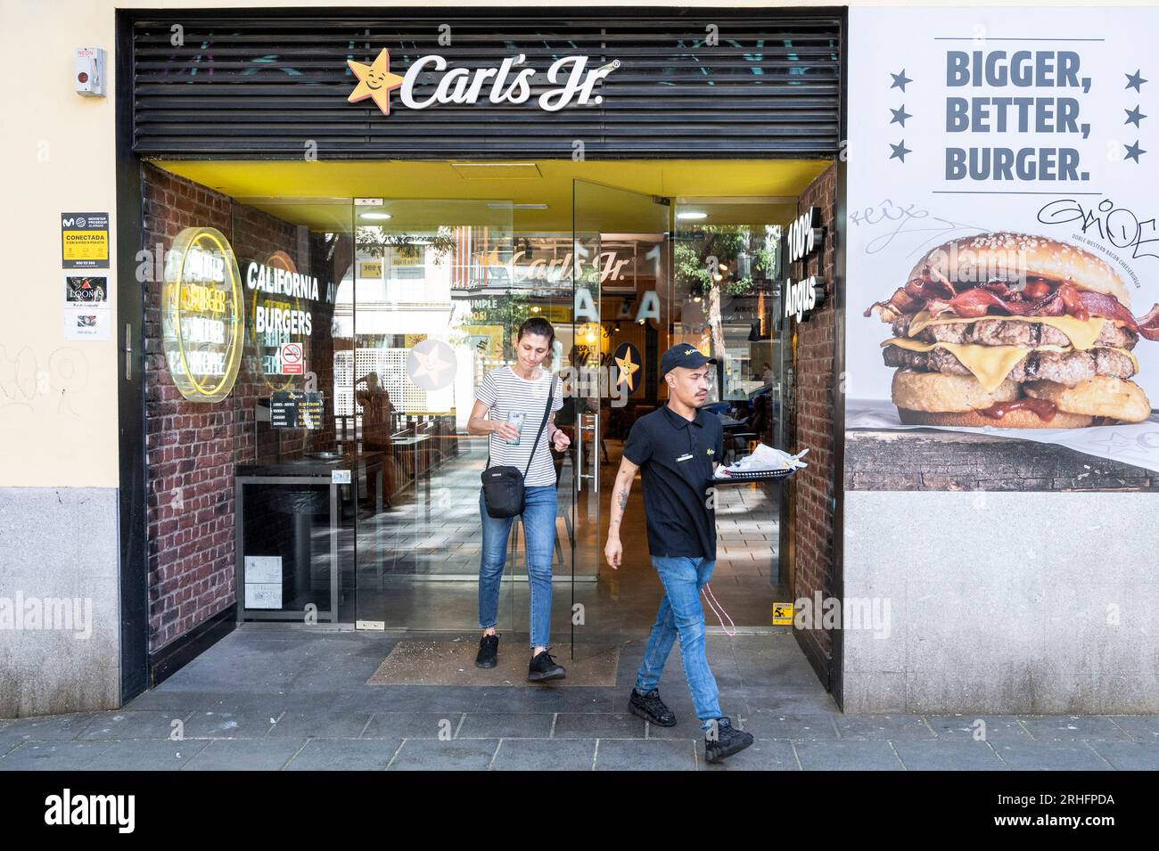 A customer is seen leaving the American fast food restaurant chain Carl ...