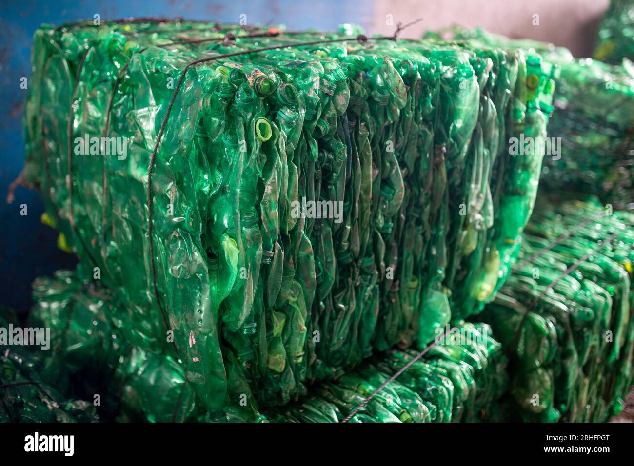 Compacted recyclable plastic bottles at a recycling plant in Dhaka ...