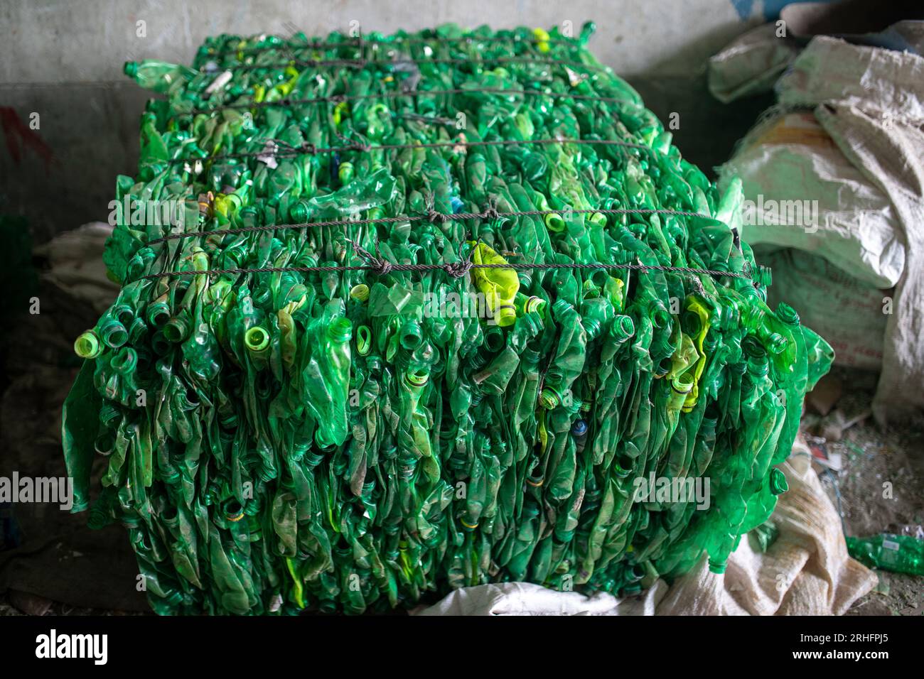 Compacted recyclable plastic bottles at a recycling plant in Dhaka ...