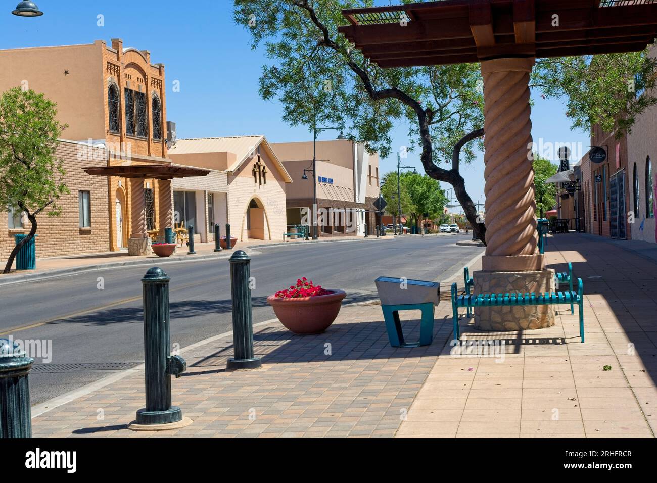 Sidewalk rest spot with benches under sun screen canopy in downtown Las ...