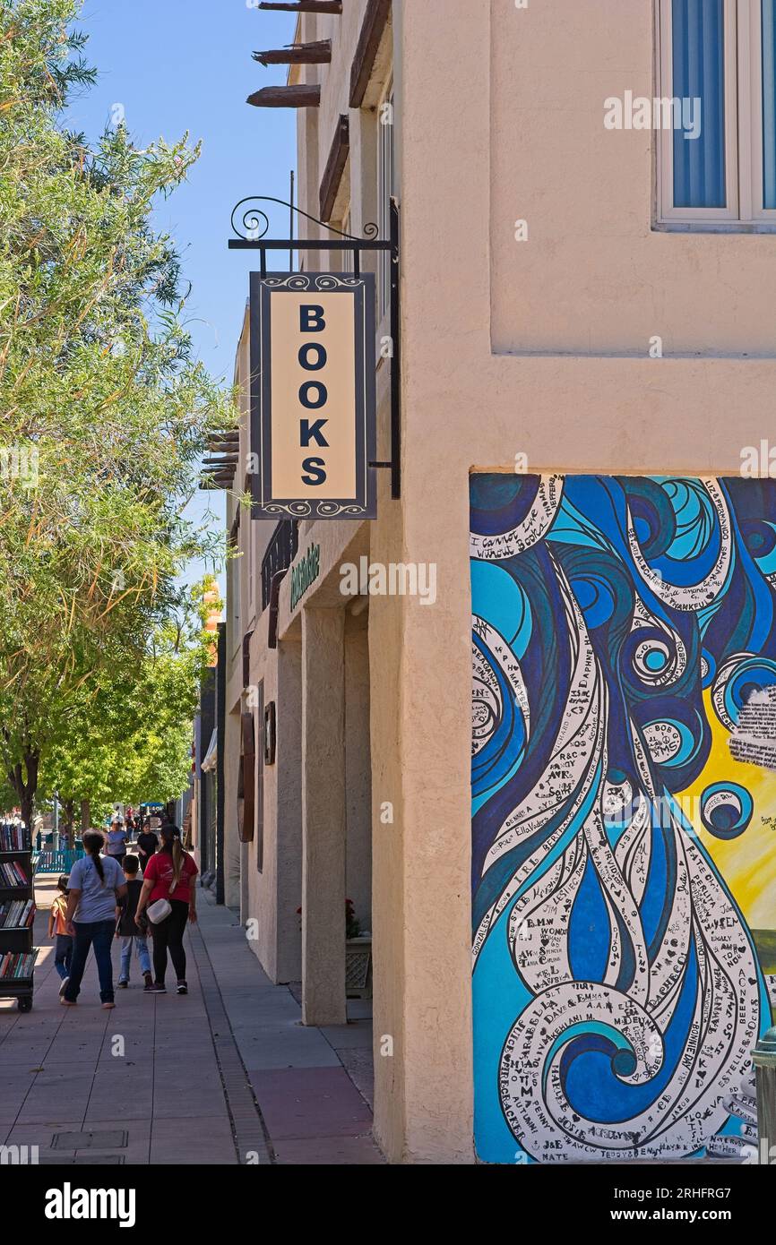 Sidewalk with pedestrians and book racks outside southwest style COAS ...