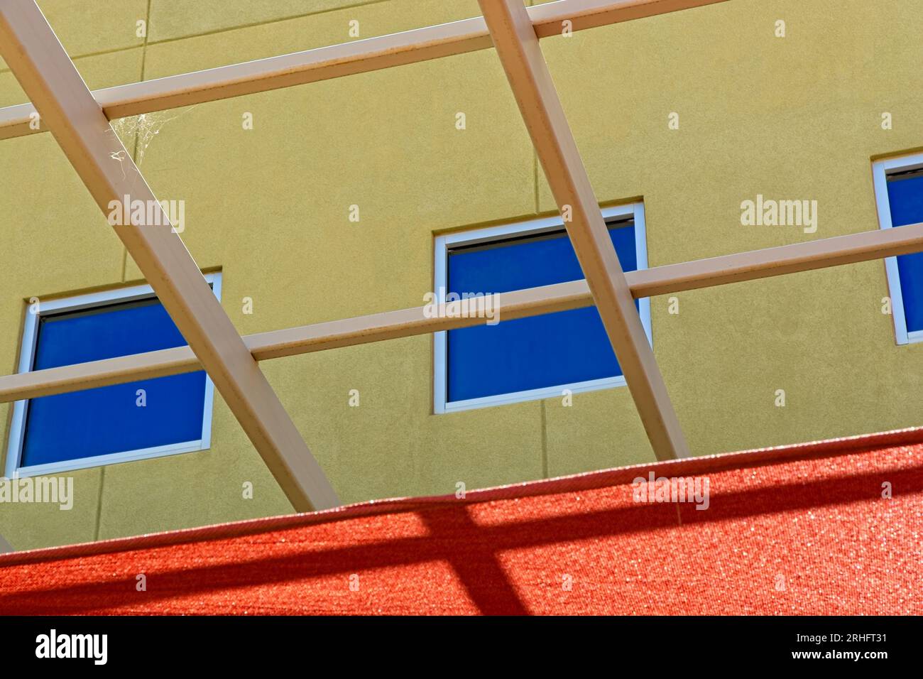 Brightly colored building facade with tube steel canopy lattice Stock ...
