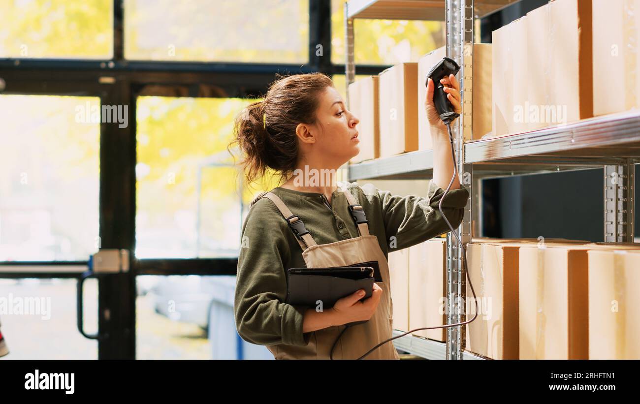 Supervisor scanning barcodes on racks, working on cargo inspection and ...