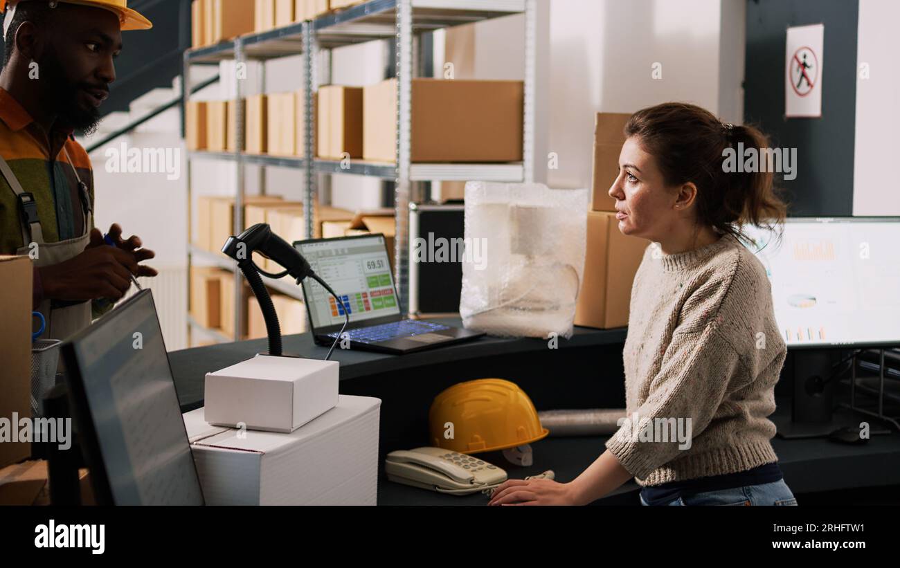 Worker carrying boxes to check barcodes and merchandise stock in ...