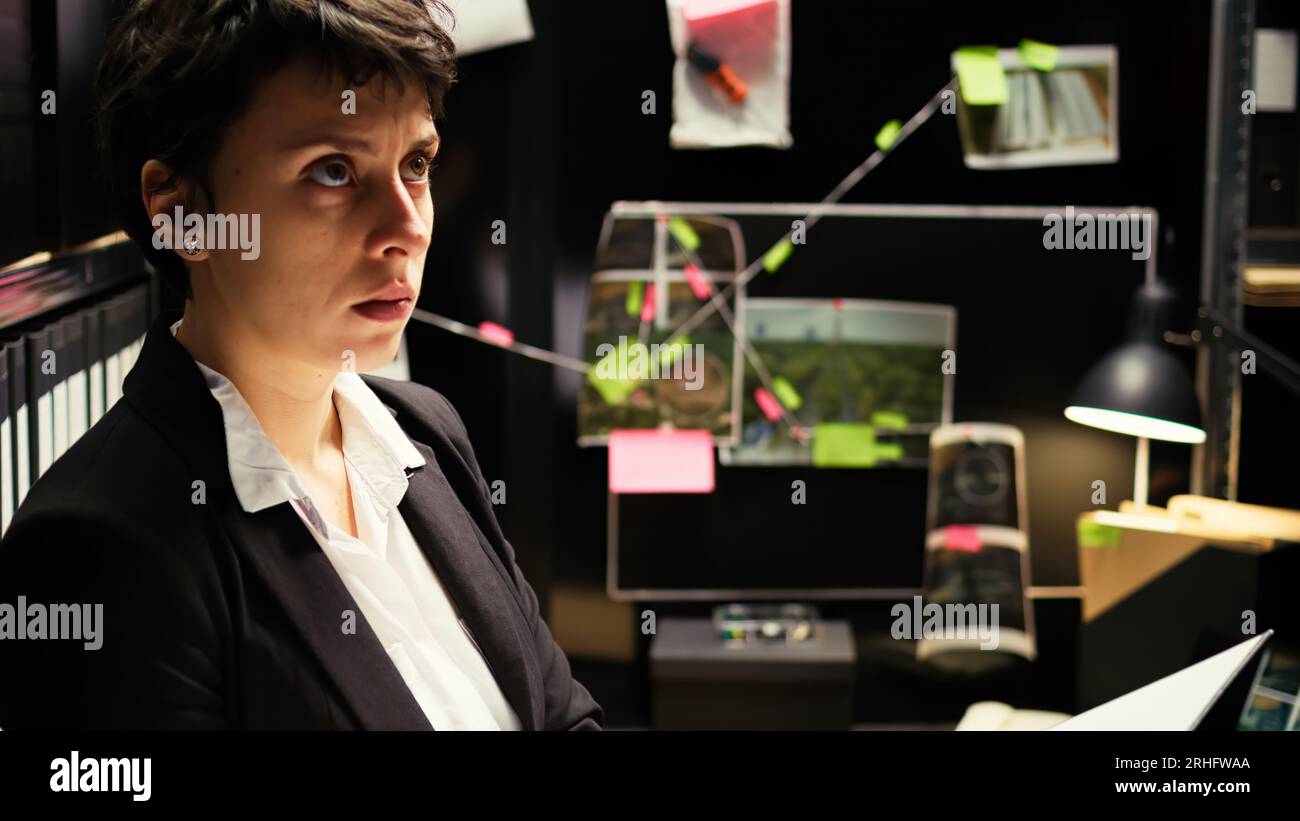 Law agent examines confidential records, trying to identify suspect on ...