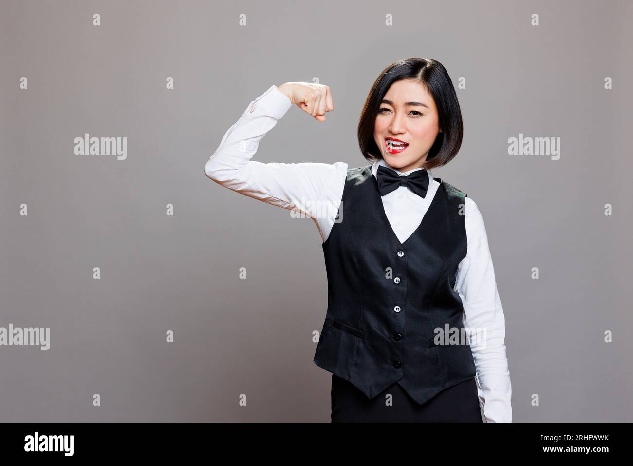 Woman flexing bicep in hotel hi-res stock photography and images - Alamy