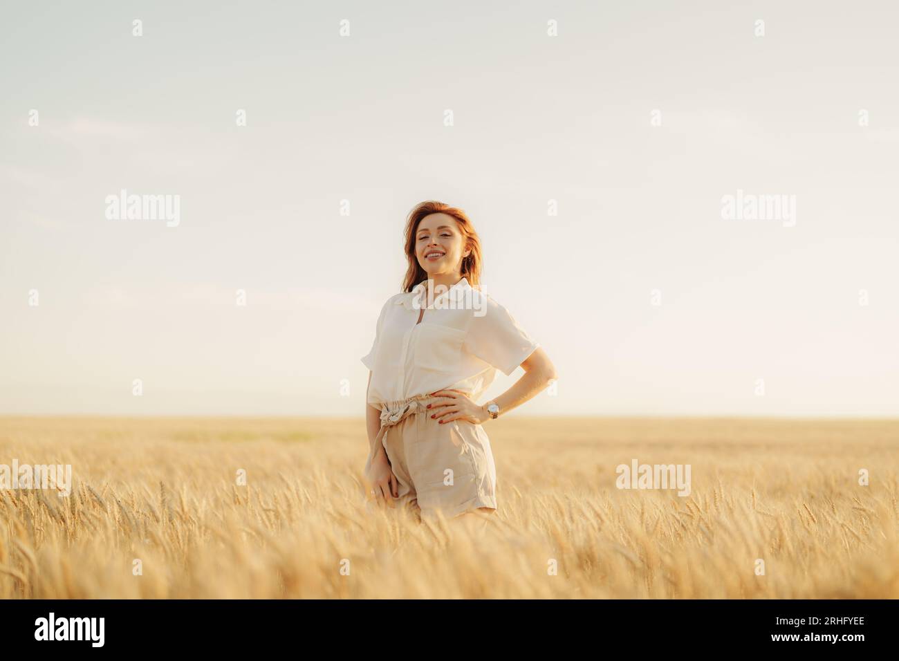 Positive young woman in summer field Stock Photo - Alamy