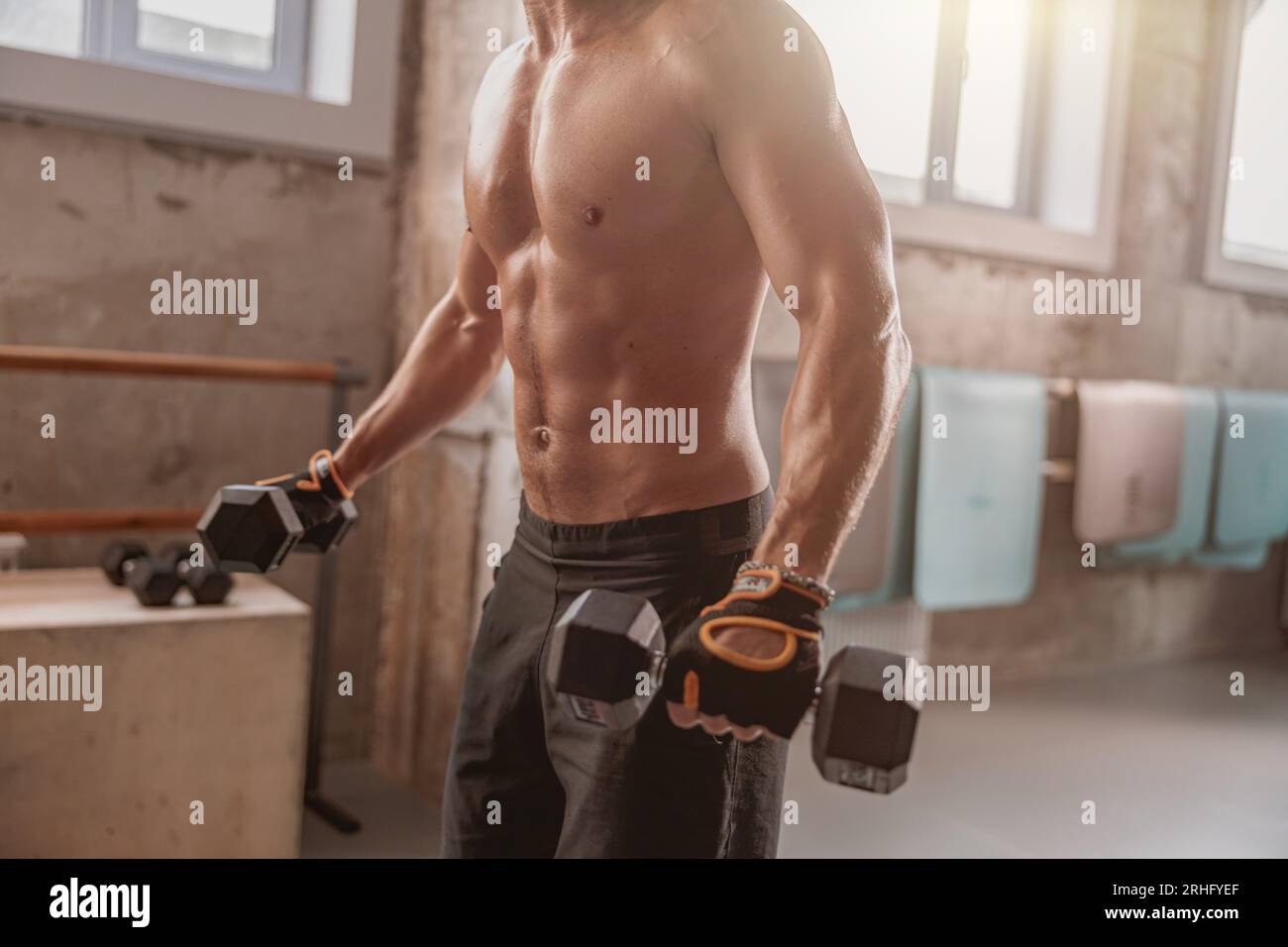 Muscular man working out in the fitness club Stock Photo - Alamy
