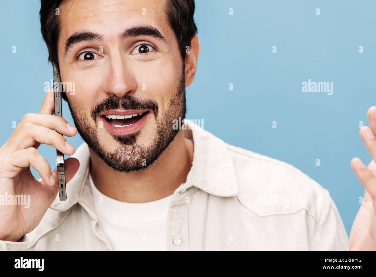 Close-up portrait of a brunette man talking on the phone, smile with ...