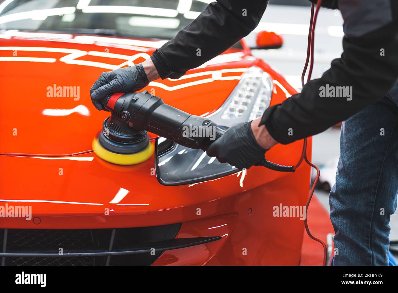 Car detailing concept. Man with black gloves and with orbital polisher ...