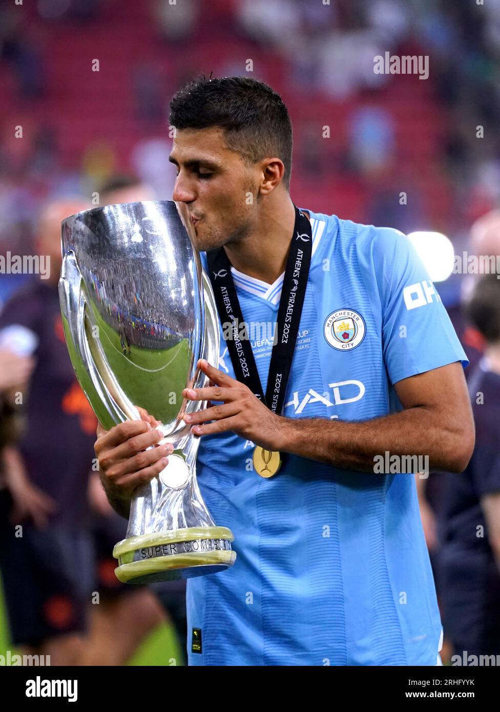 Manchester City's Rodri kisses the UEFA Super Cup trophy as he ...