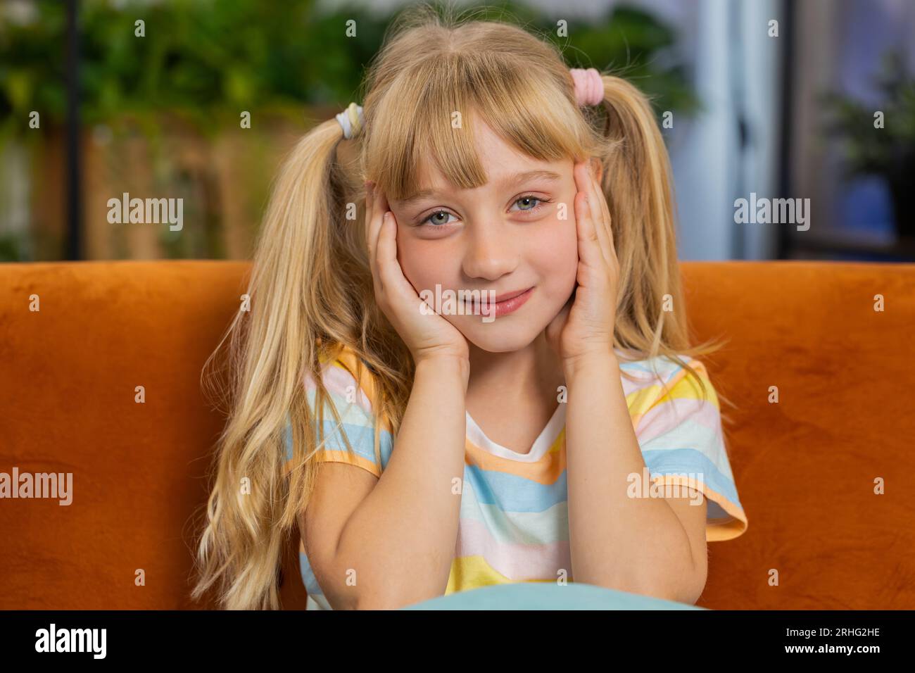 Close-up portrait of happy smiling Caucasian preteen school girl 7 years old. Young blonde ...