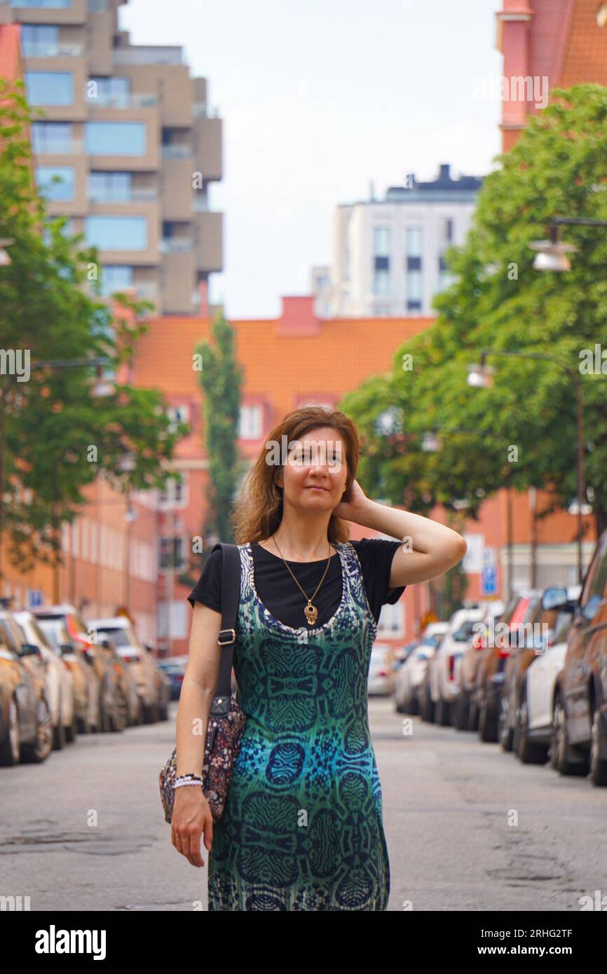 Woman standing by road hi-res stock photography and images - Alamy
