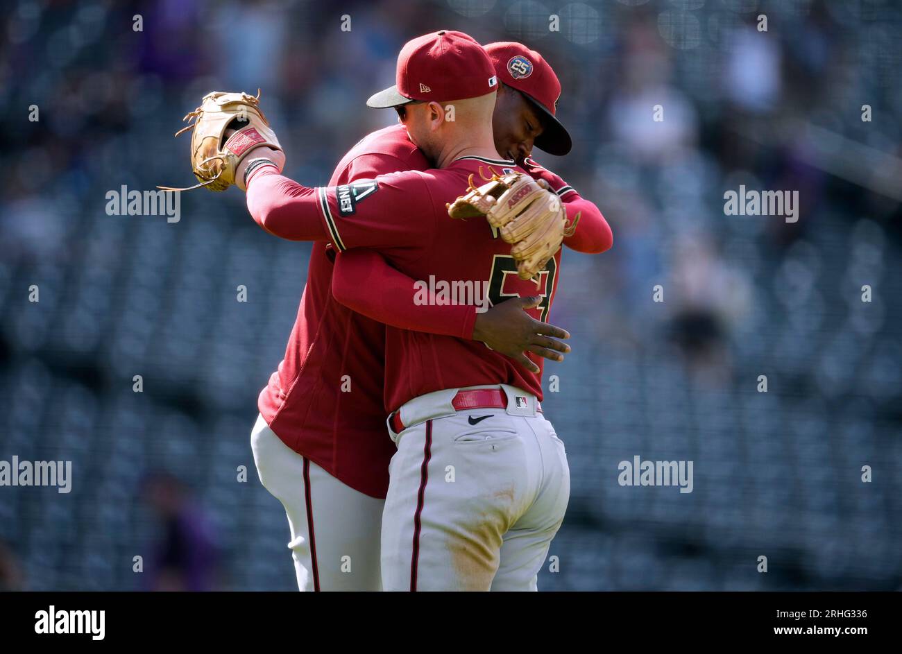 Arizona Diamondbacks third baseman Geraldo Perdomo, back, hugs first ...