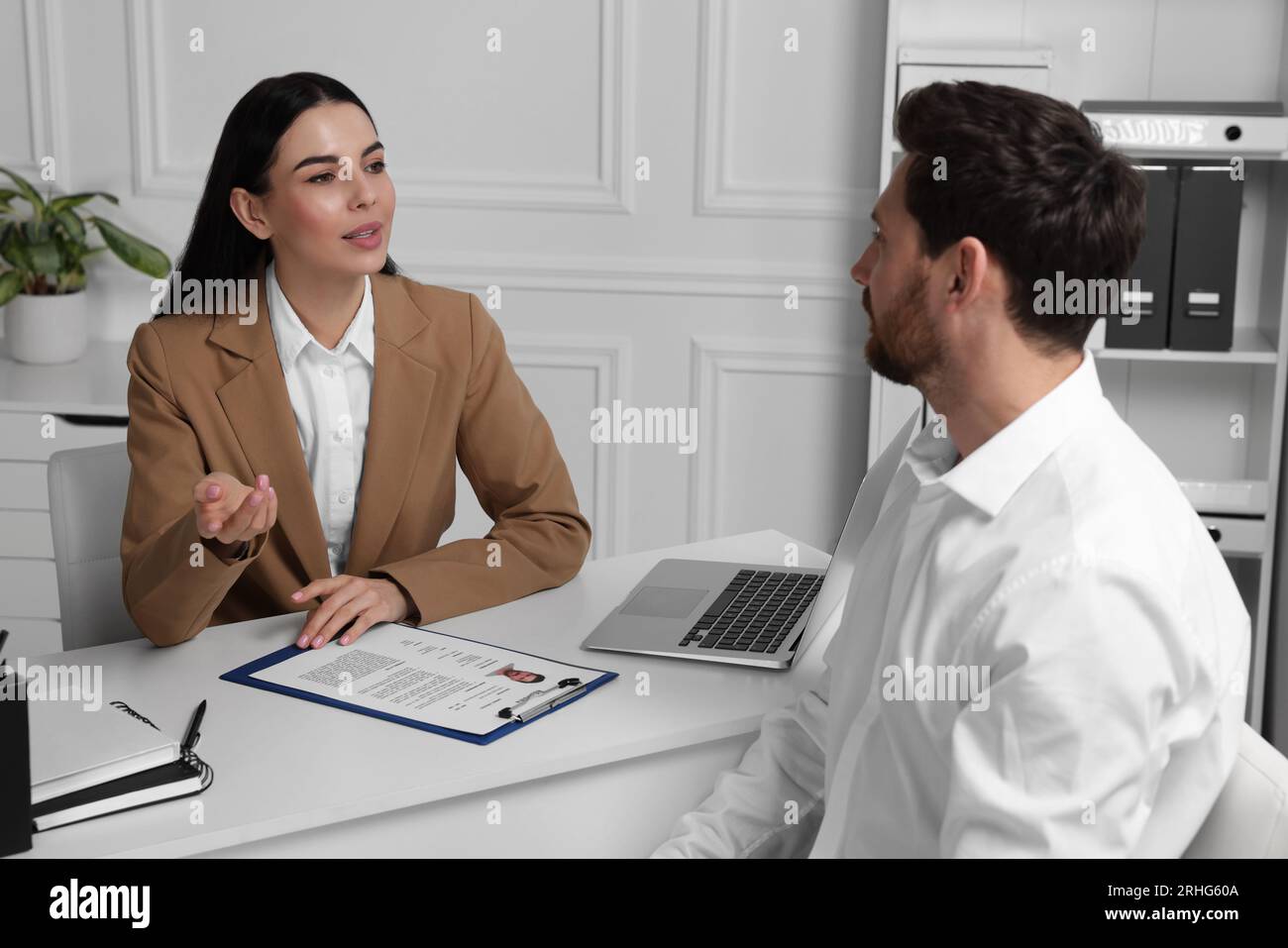 Human resources manager conducting job interview with applicant in office Stock Photo - Alamy