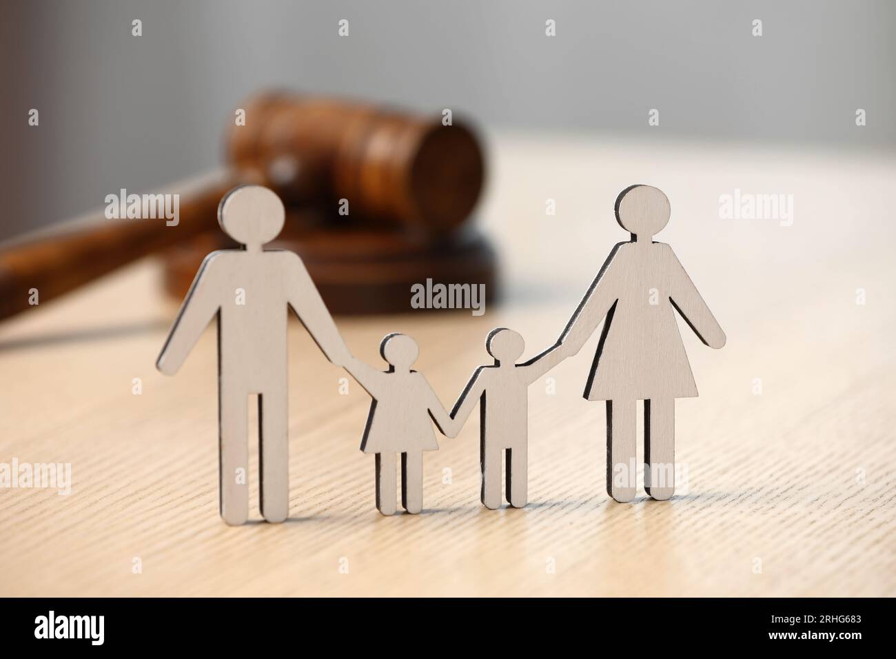 Family law. Figure of parents with children and gavel on wooden table ...