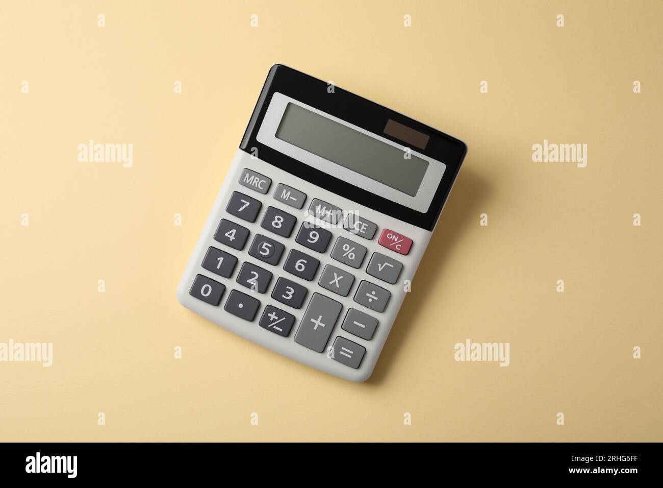 Calculator on beige background, top view. Office equipment Stock Photo ...