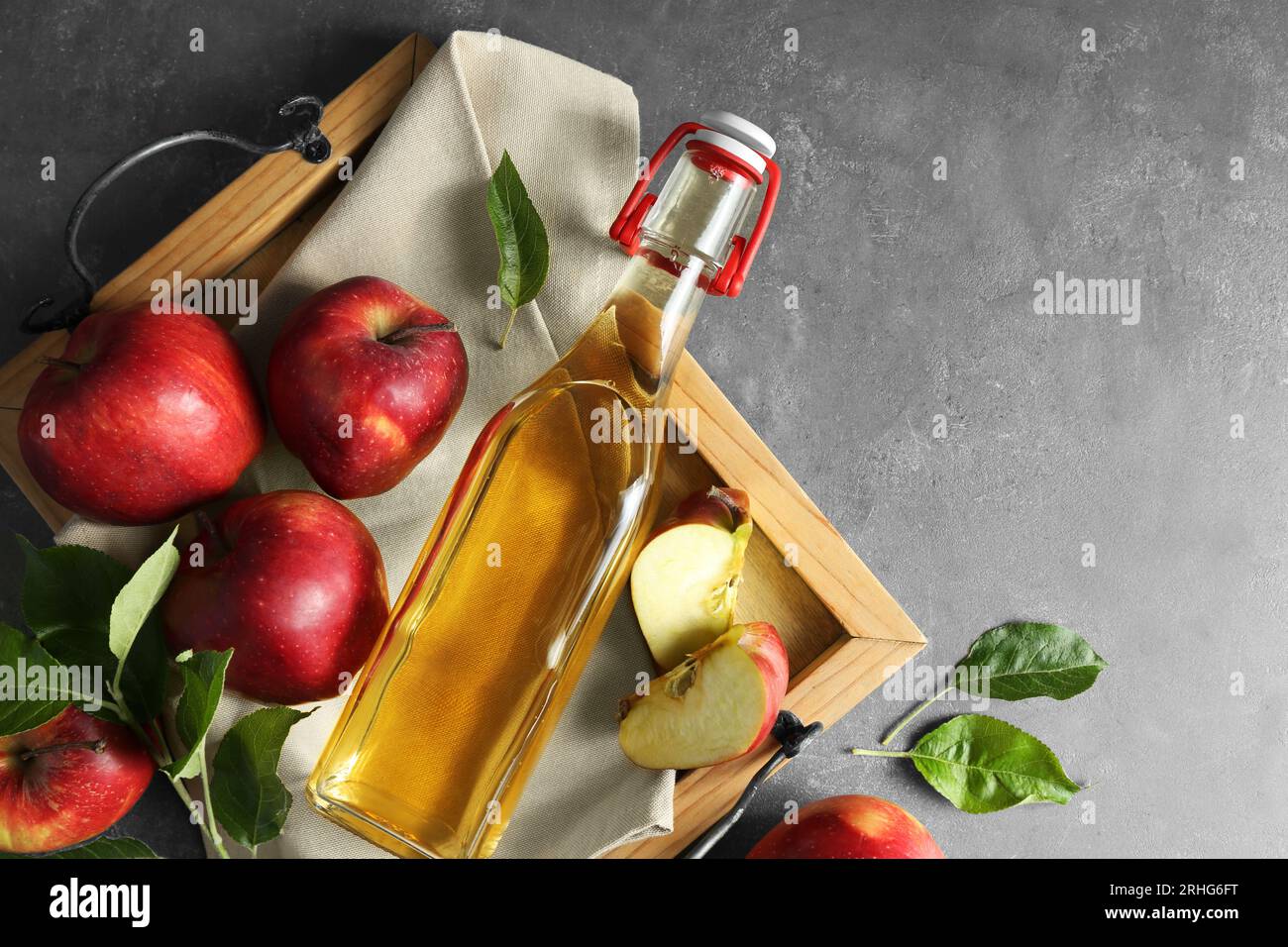 Flat lay composition with delicious apple cider on gray table, space ...