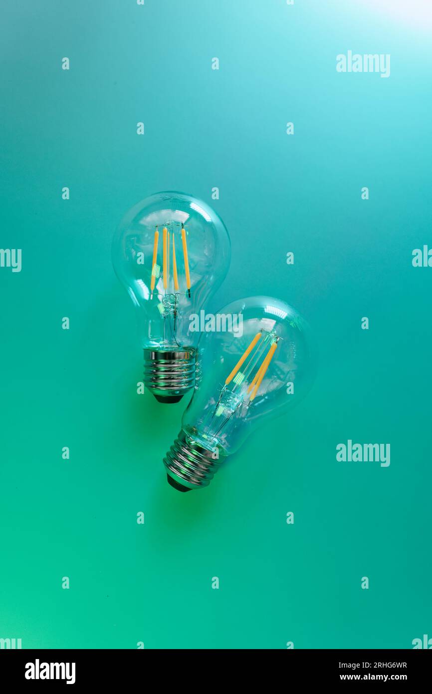 Green energy. Electric light bulbs on a turquoise background with a ...
