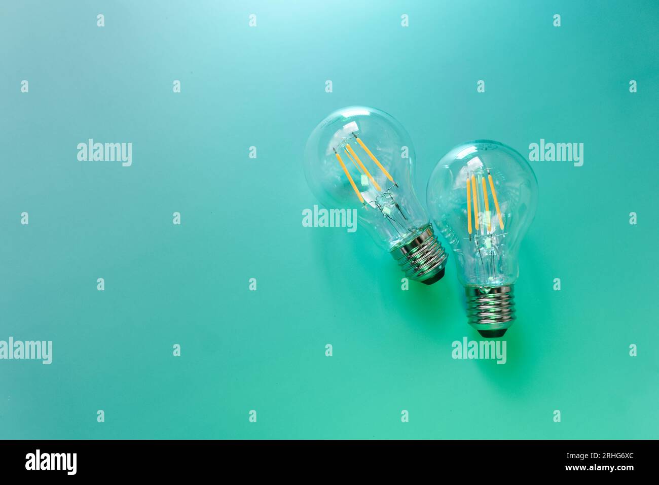 Electricity background.Electric light bulbs on a turquoise background ...