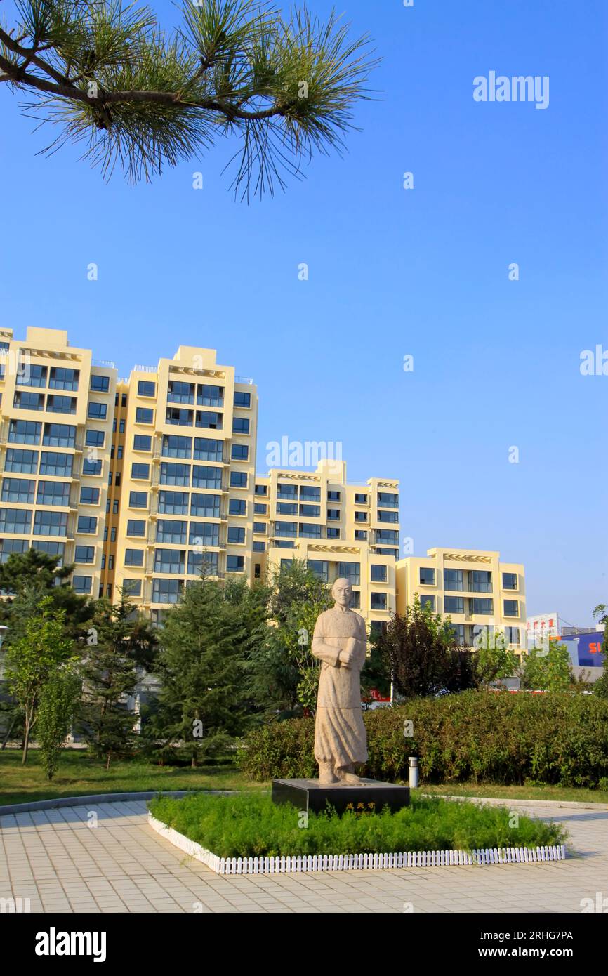 building and flowers in a city square, north china Stock Photo - Alamy