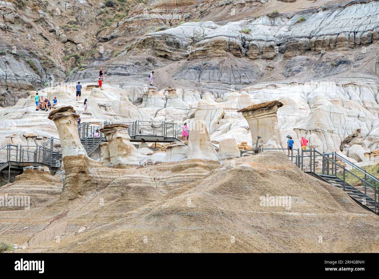 Visitors enjoyingexploring the rock formations near the hoodoos at ...