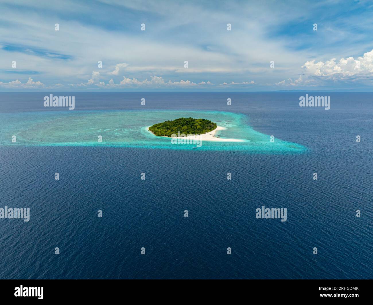 Mantigue Island covered in lush tropical trees. Camiguin, Philippines ...