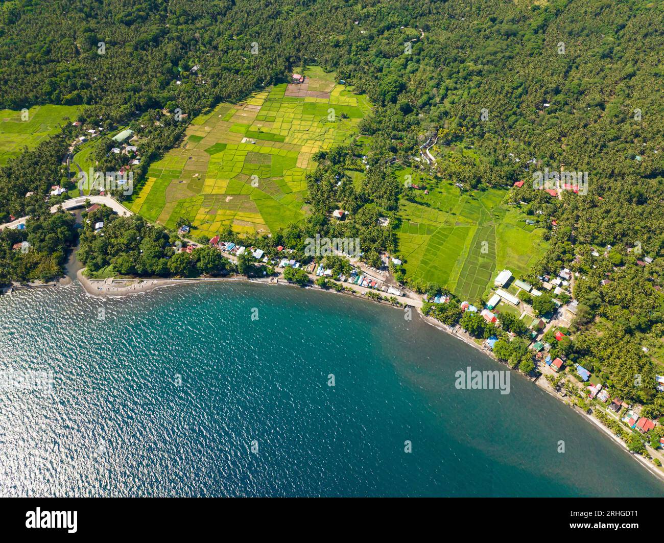 Sun reflection on sea water and farmland in coastline of Camiguin ...