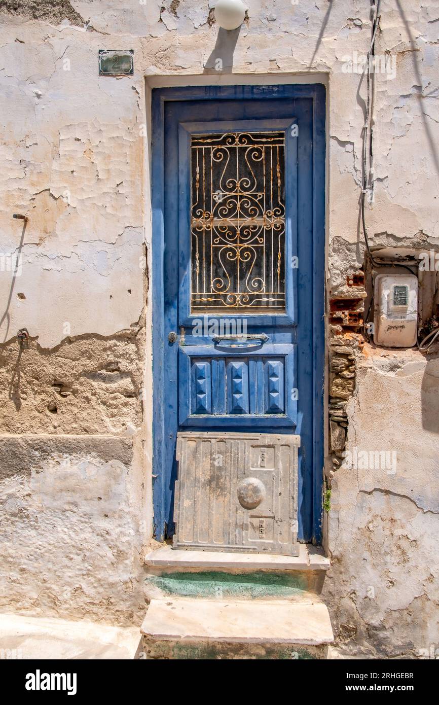 Old weather-worn Greek buildings-cracked walls and peeling paint, decay ...