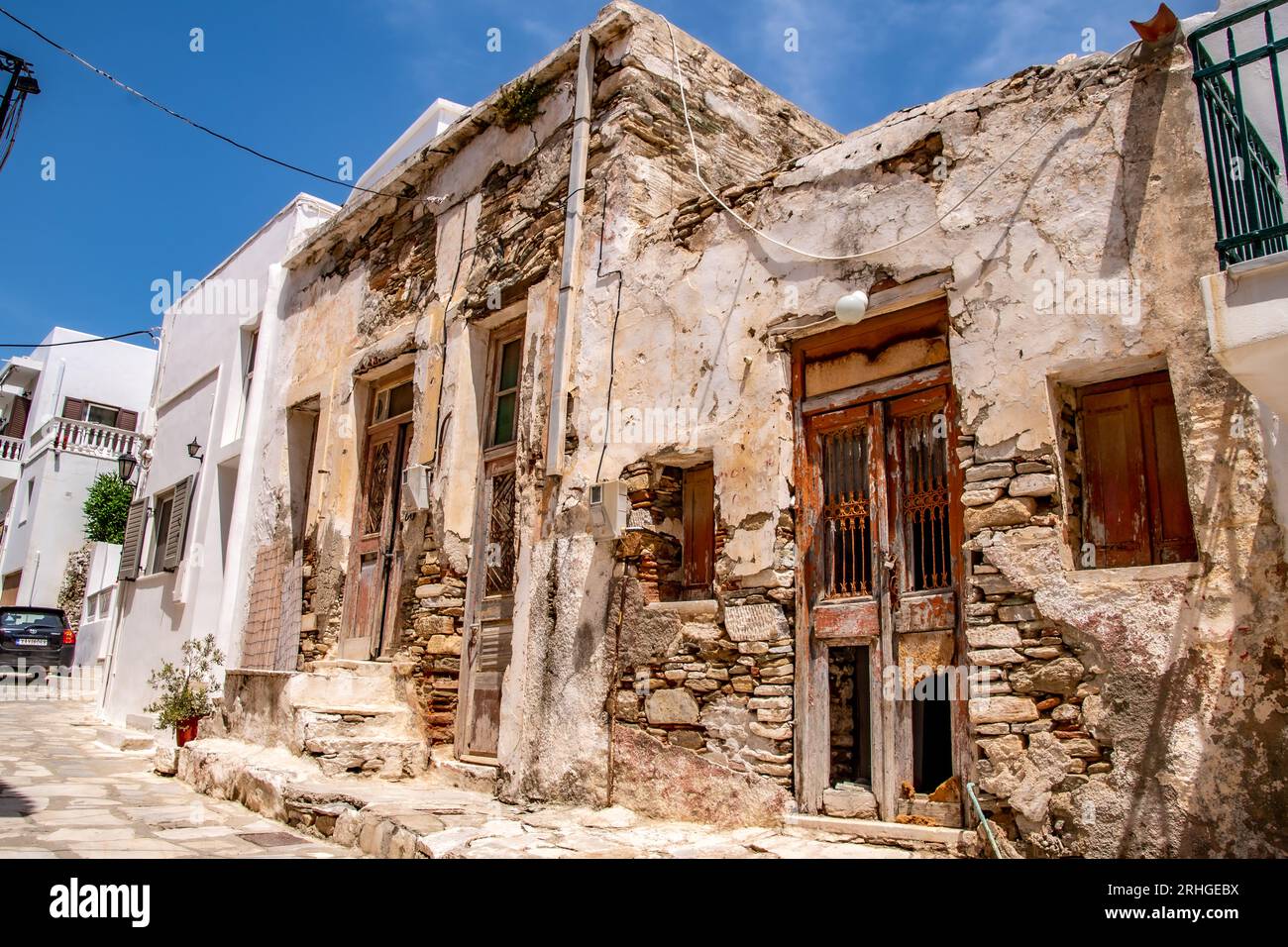 Old weather-worn Greek buildings-cracked walls and peeling paint, decay ...