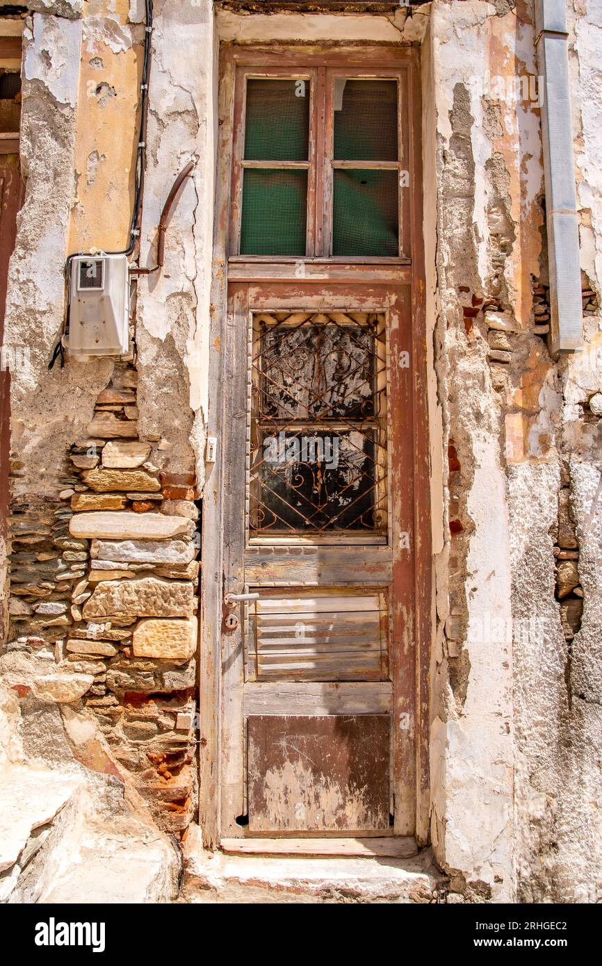 Old weather-worn Greek buildings-cracked walls and peeling paint, decay ...