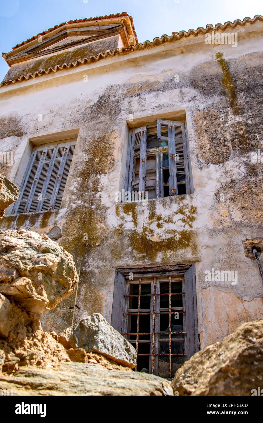 Old weather-worn Greek buildings-cracked walls and peeling paint, decay ...