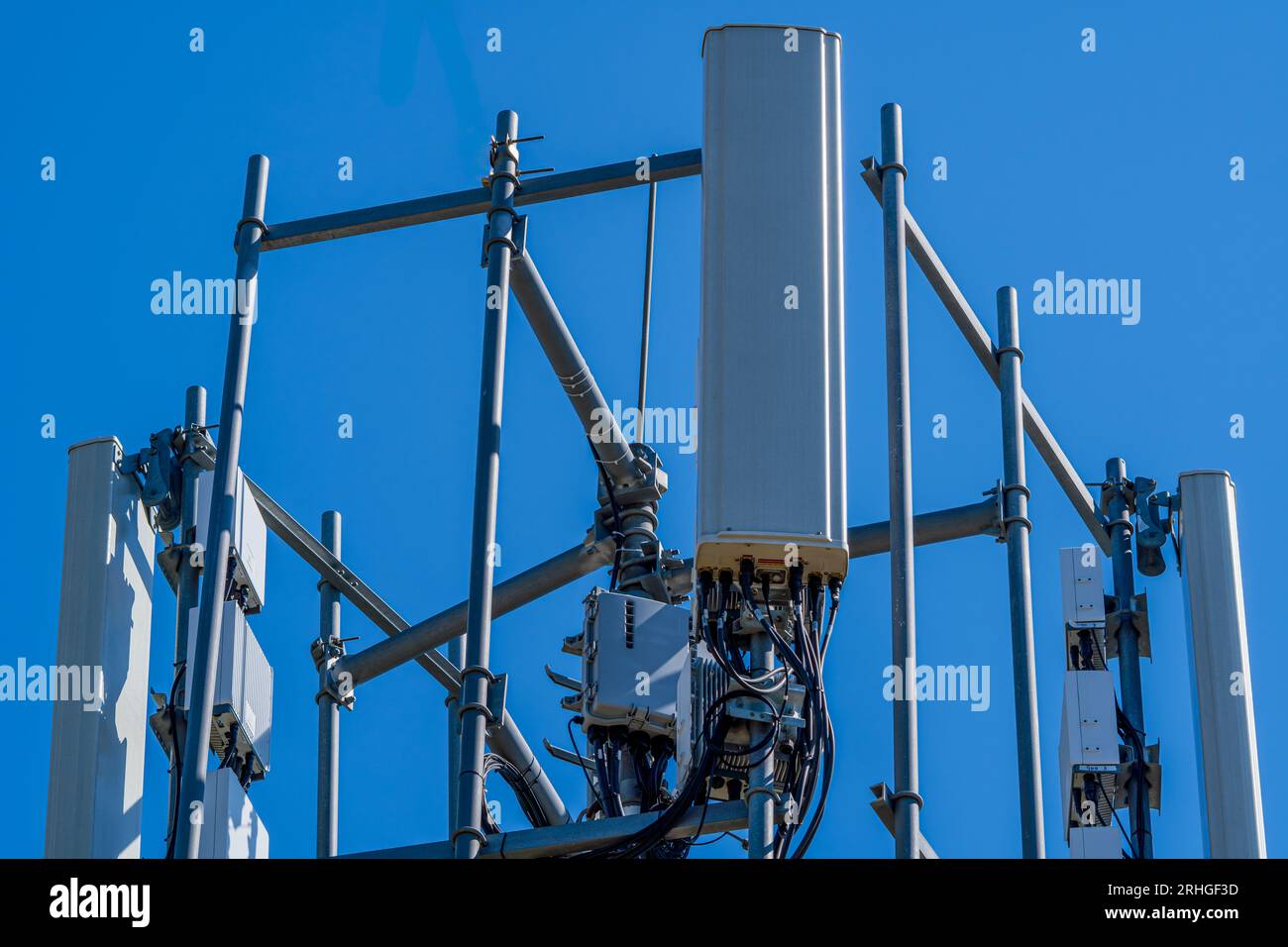 Close-up of tower with 6G, 5G, 4G cellular network antenna on blue sky background Stock Photo ...