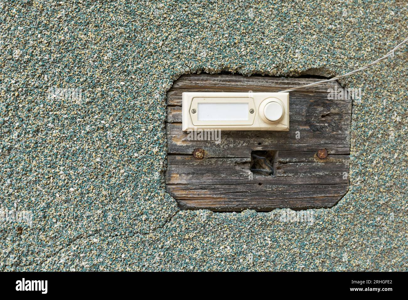 Unprofessionally installed bell button in the entrance area of a house ...