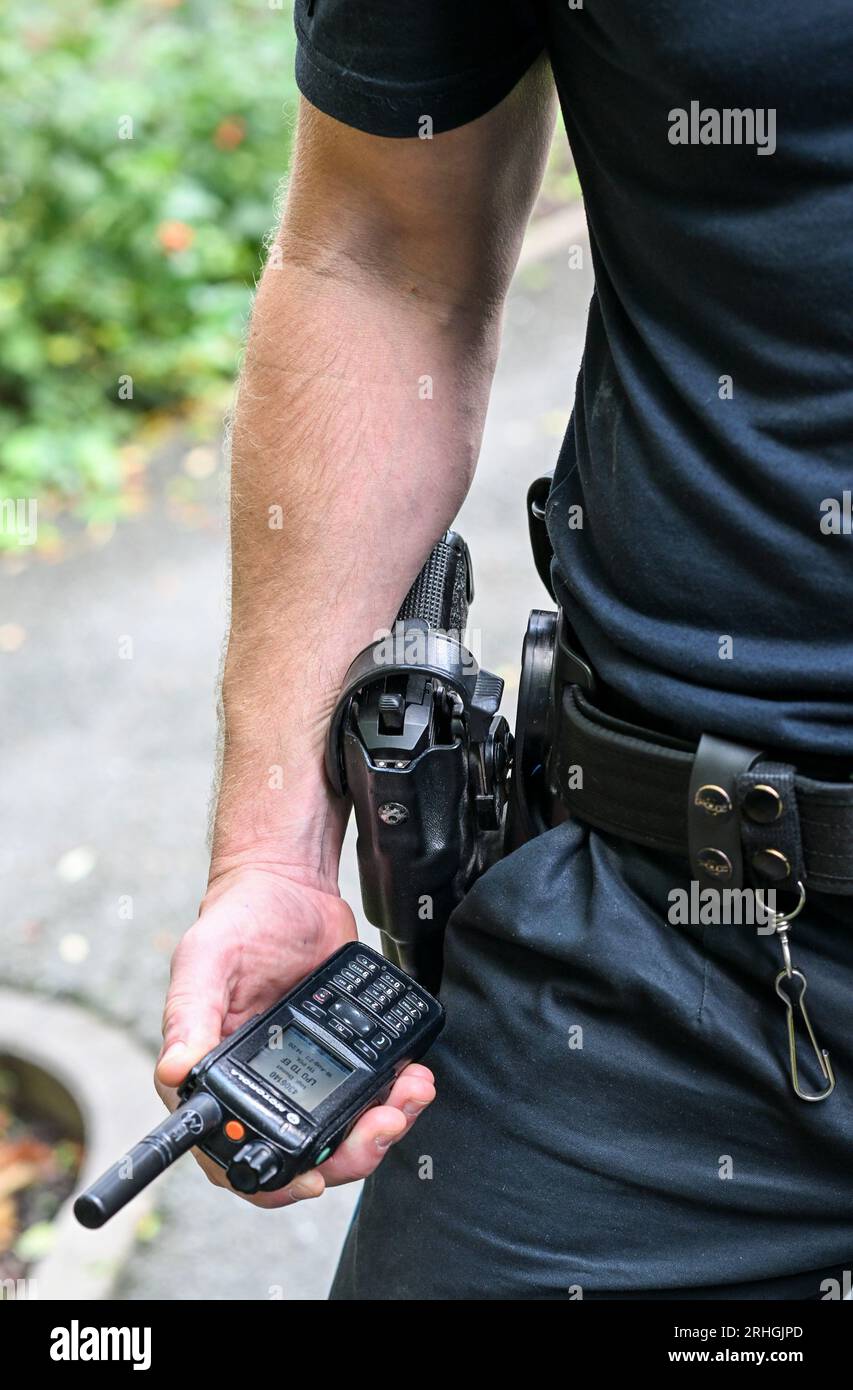Erfurt, Germany. 16th Aug, 2023. A police officer with a digital radio ...
