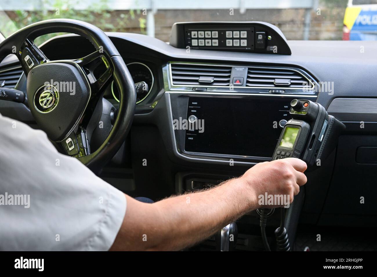 Erfurt, Germany. 16th Aug, 2023. A police officer reaches for a digital ...