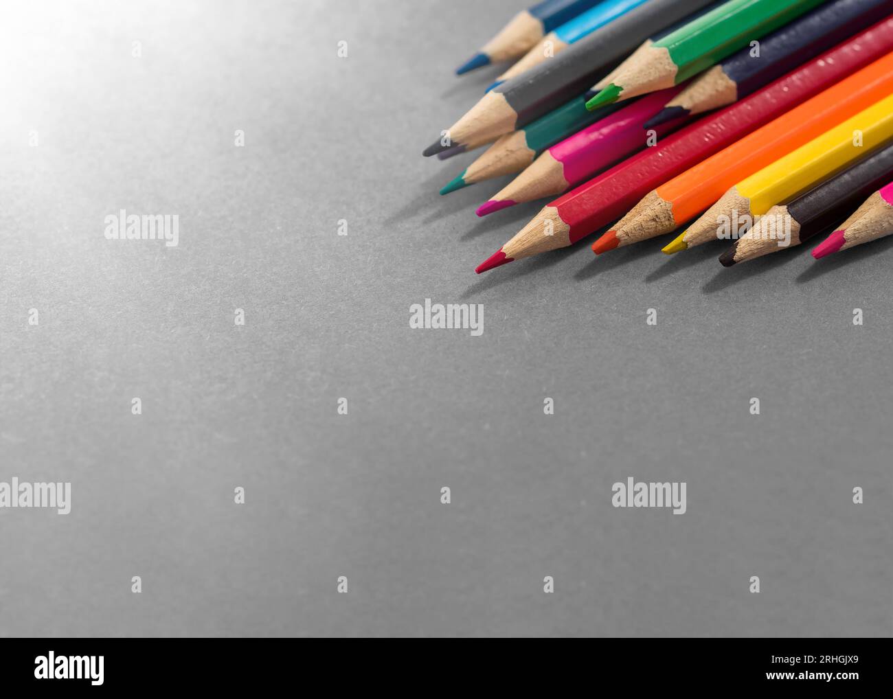 Colored pencils on gray background. Empty place for text or drawing on ...