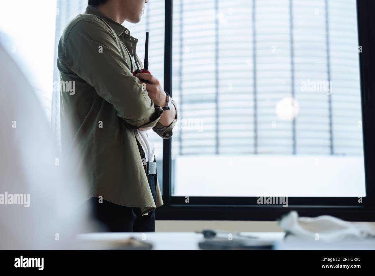 Architect standing in building in construction process with arms ...